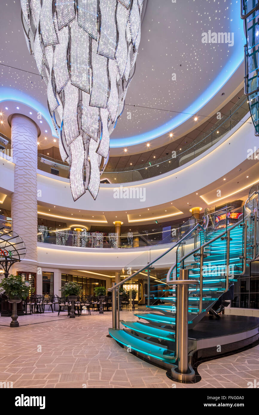 Central atrium with colour changing chandelier and glass staircase ...