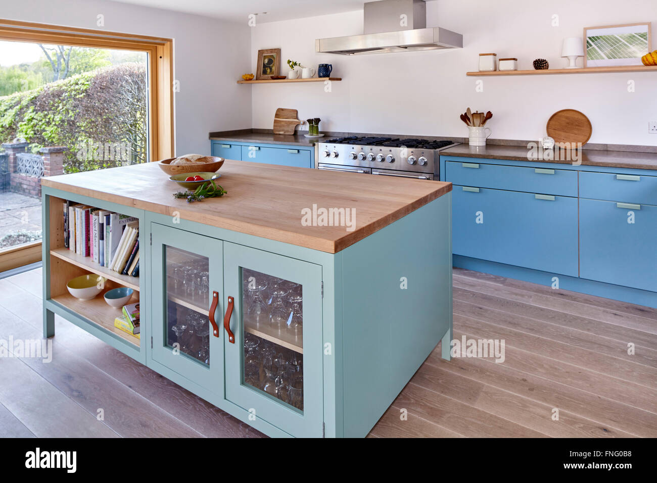 Oblique view of contemporary kitchen design with island, shelves and ...