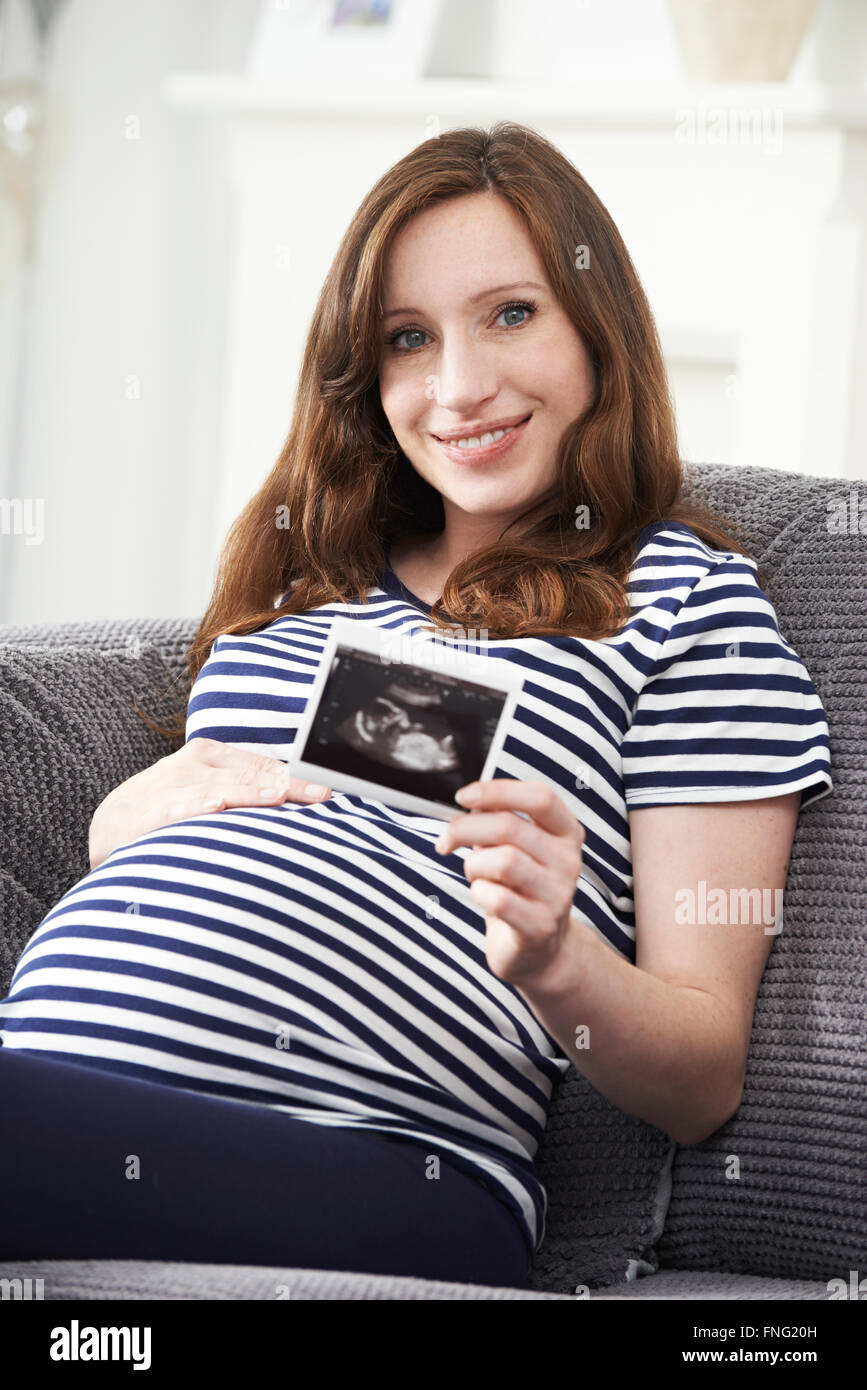 Portrait Of Pregnant Woman Holding Ultrasound Scan Of Baby Stock Photo ...