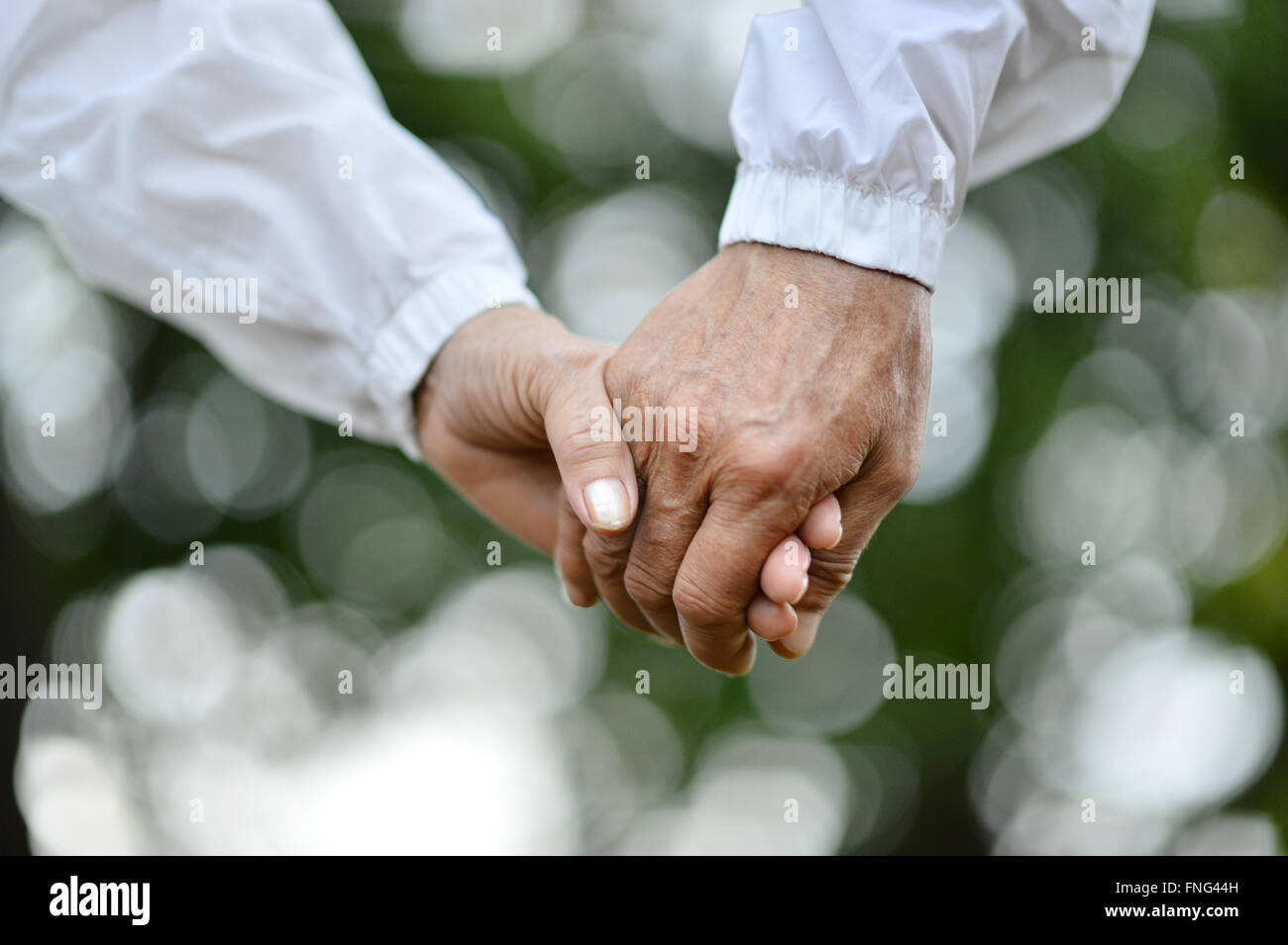 Hands held together Stock Photo - Alamy