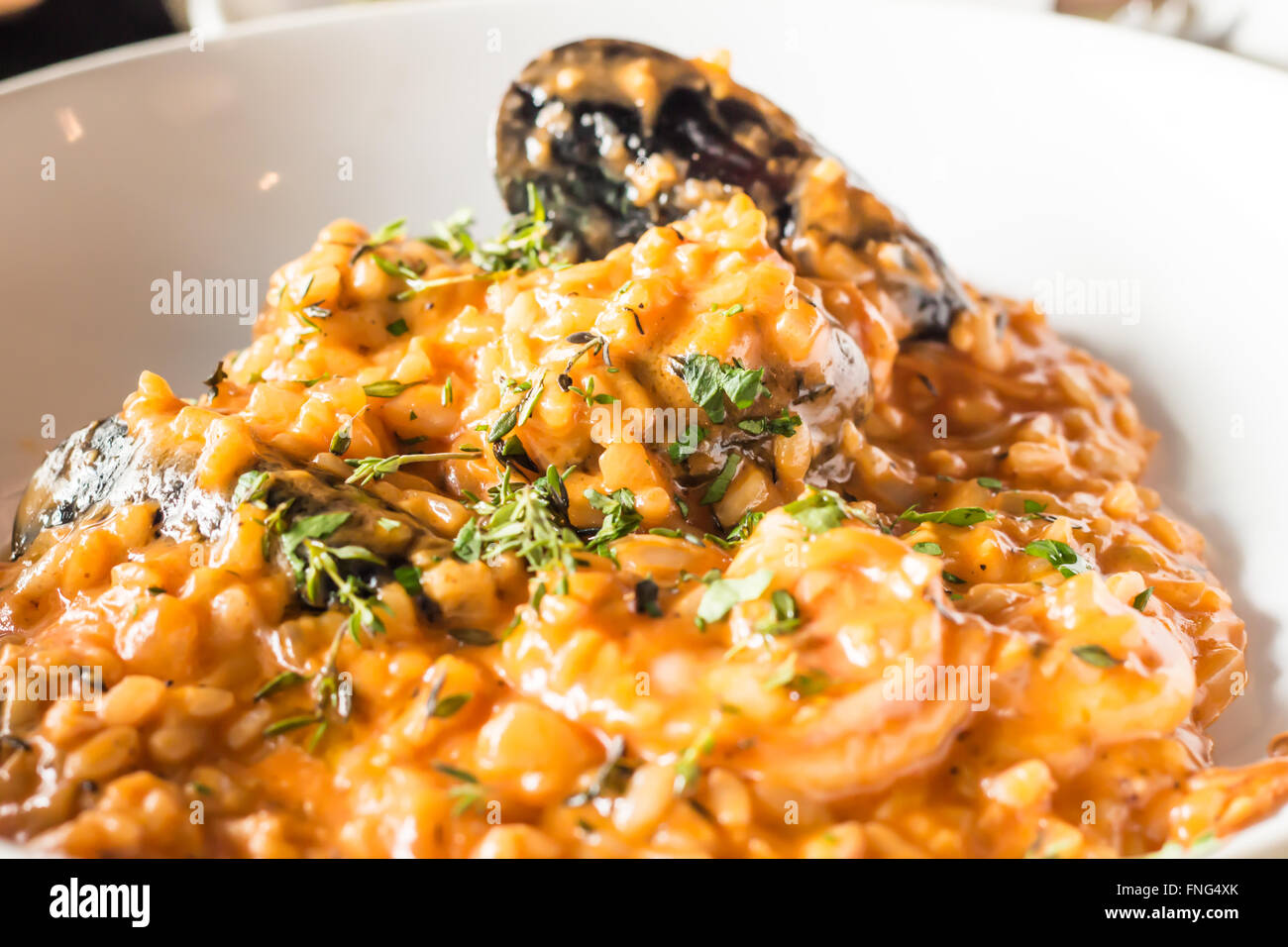 Seafood risotto on white plate Stock Photo - Alamy