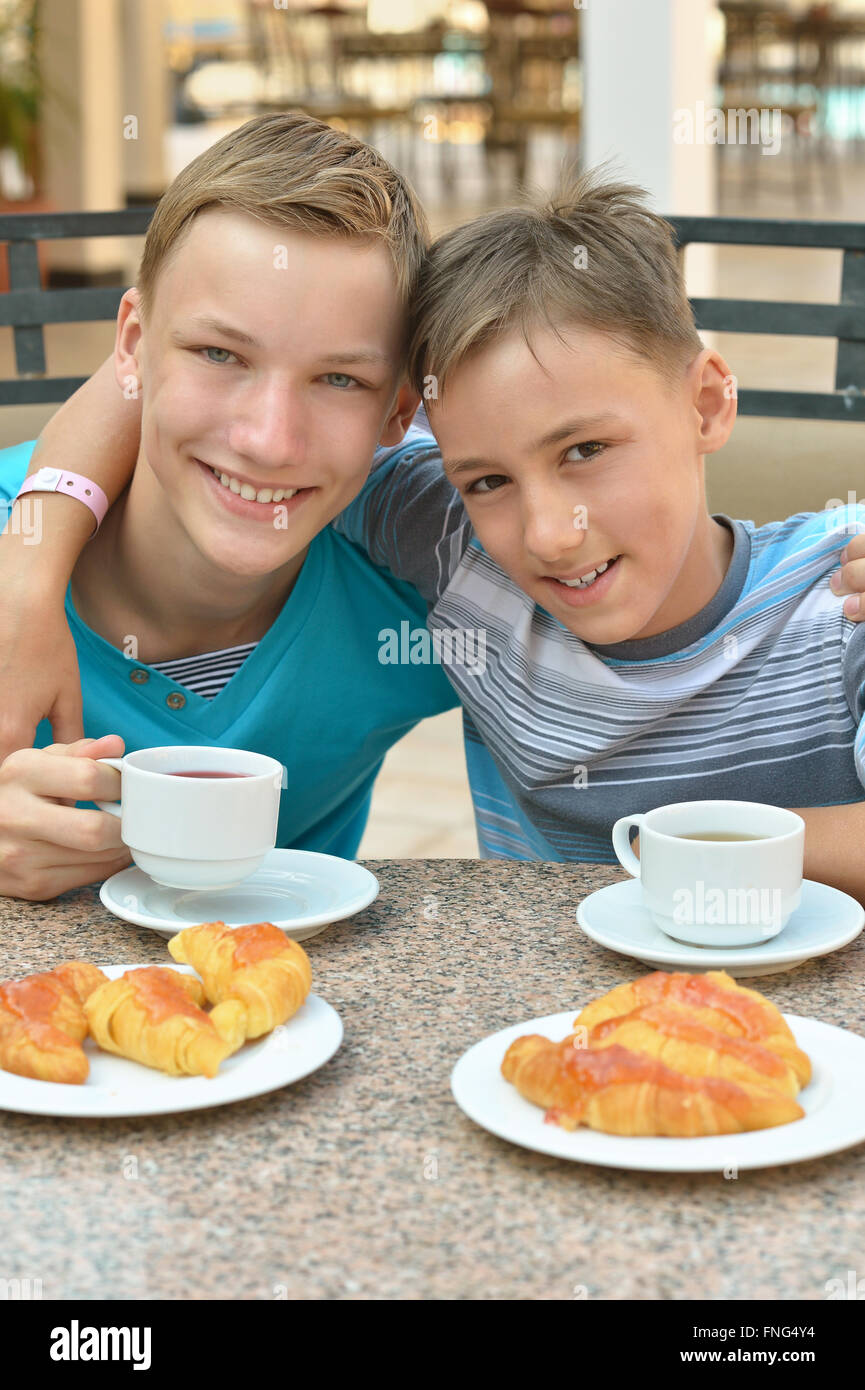 Happy children at breakfast Stock Photo - Alamy