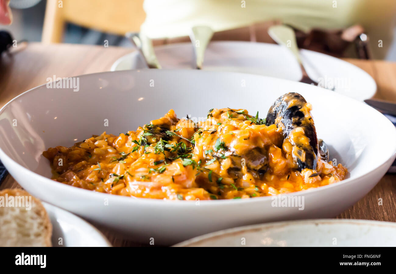Seafood risotto on white plate Stock Photo - Alamy