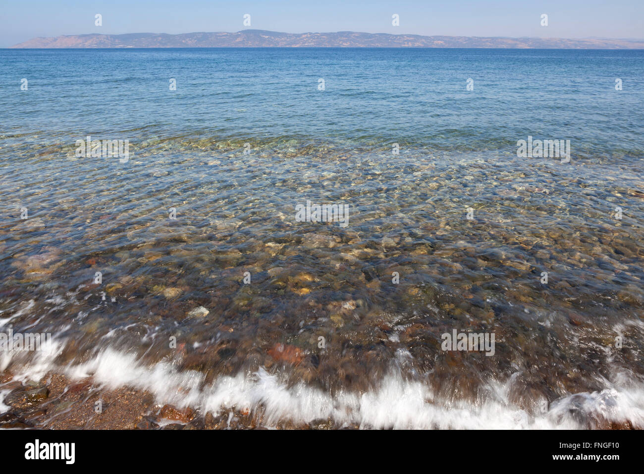 Clear sea water waves washing over pebbles in the Aegean Sea Stock ...