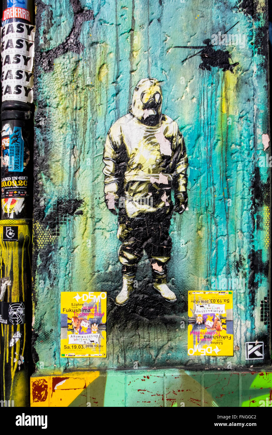 Street art, Graffiti. Man, gas mask, protective clothies and helicopter ...