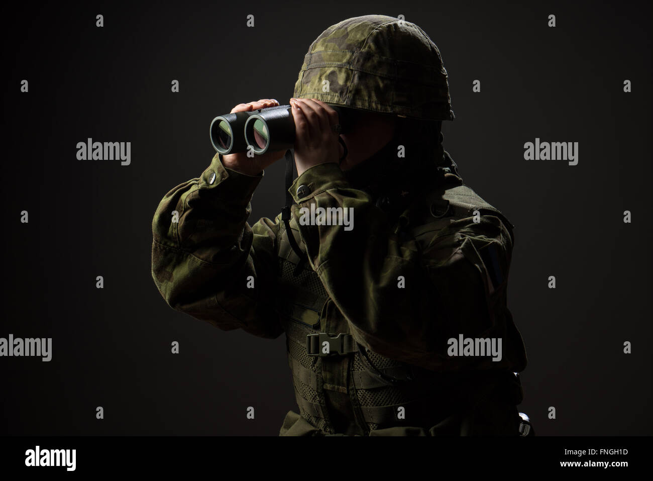 Portrait of unarmed woman with camouflage. Young female soldier observe ...