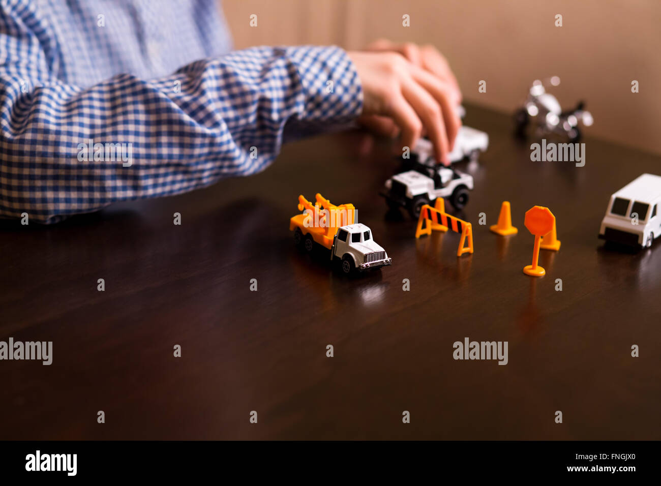 Boy's hand moves toy jeep Stock Photo - Alamy