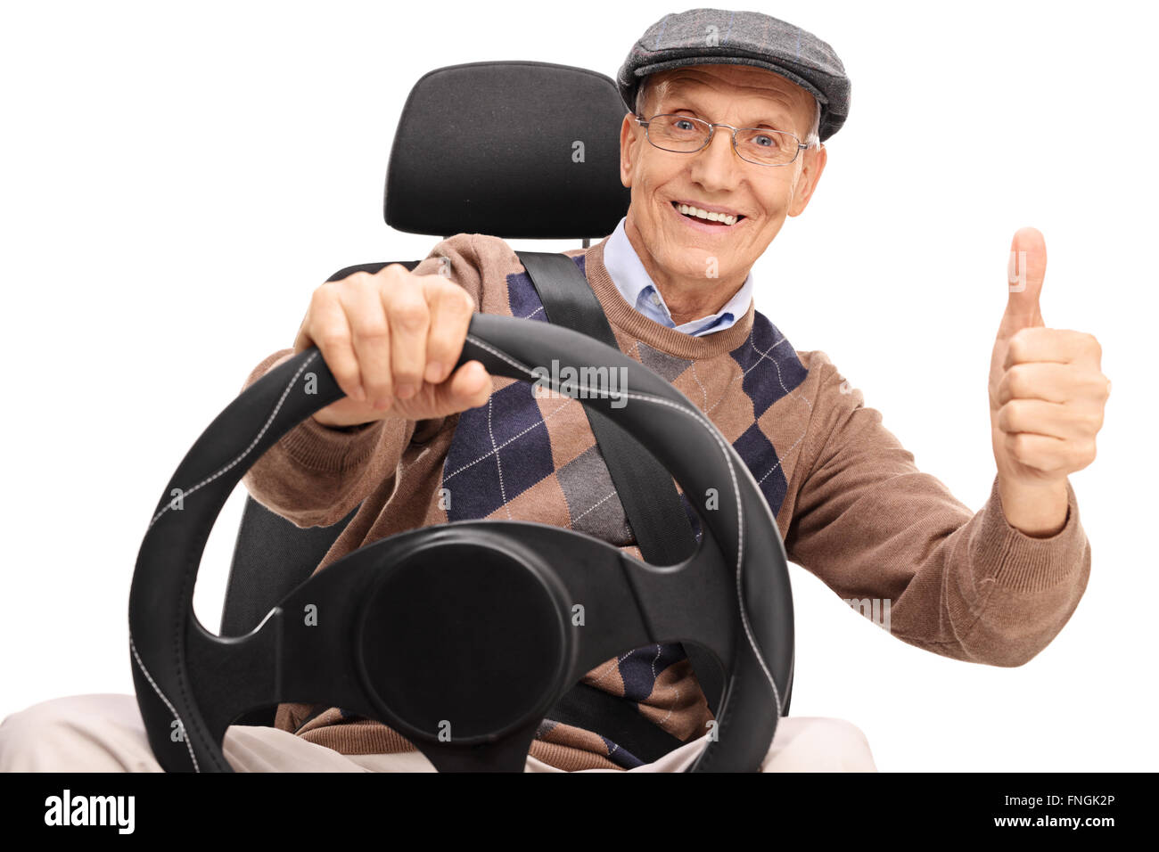 Studio shot of a senior man driving and giving a thumb up isolated on ...