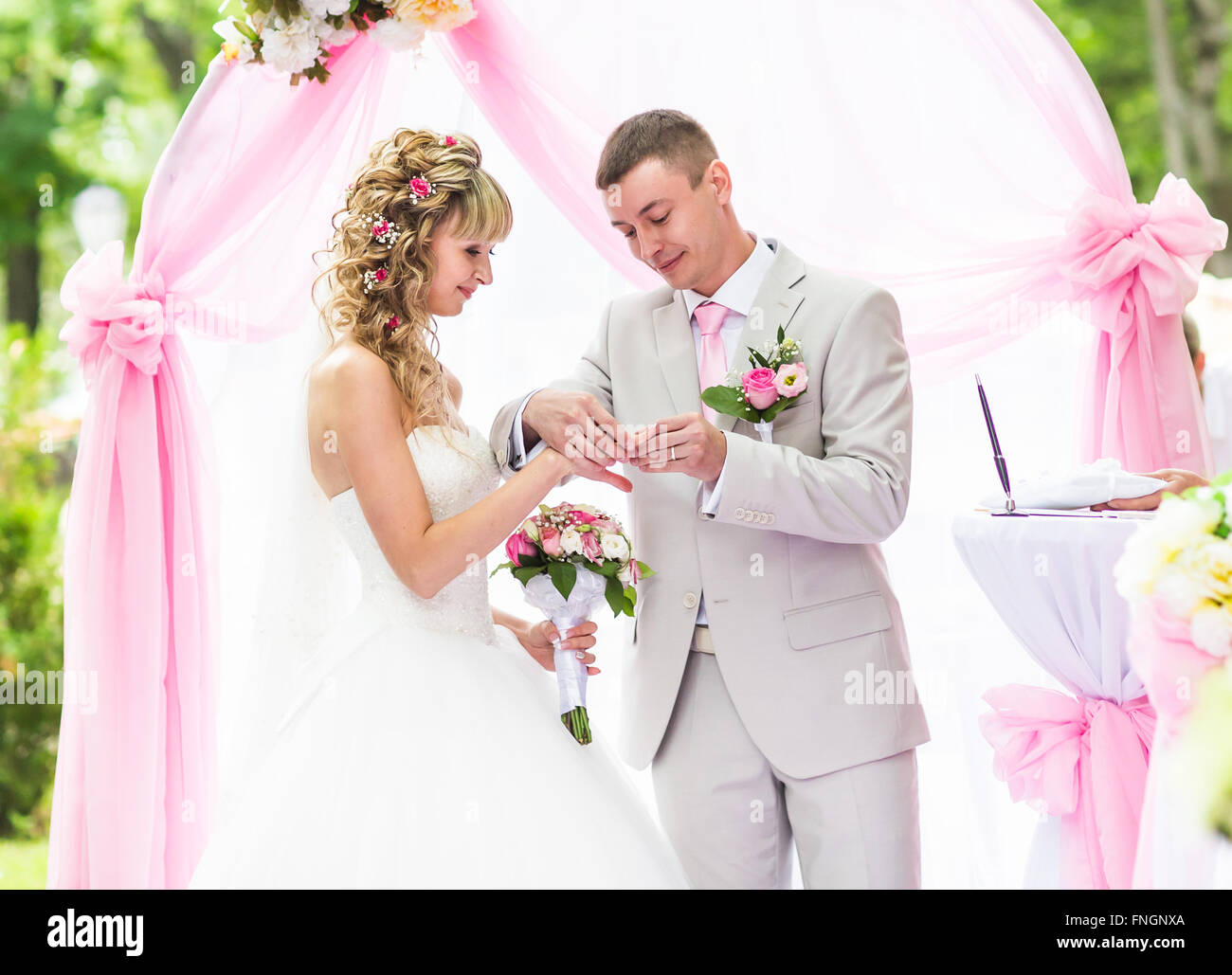 Putting wedding ring on finger during ceremony hi-res stock photography ...