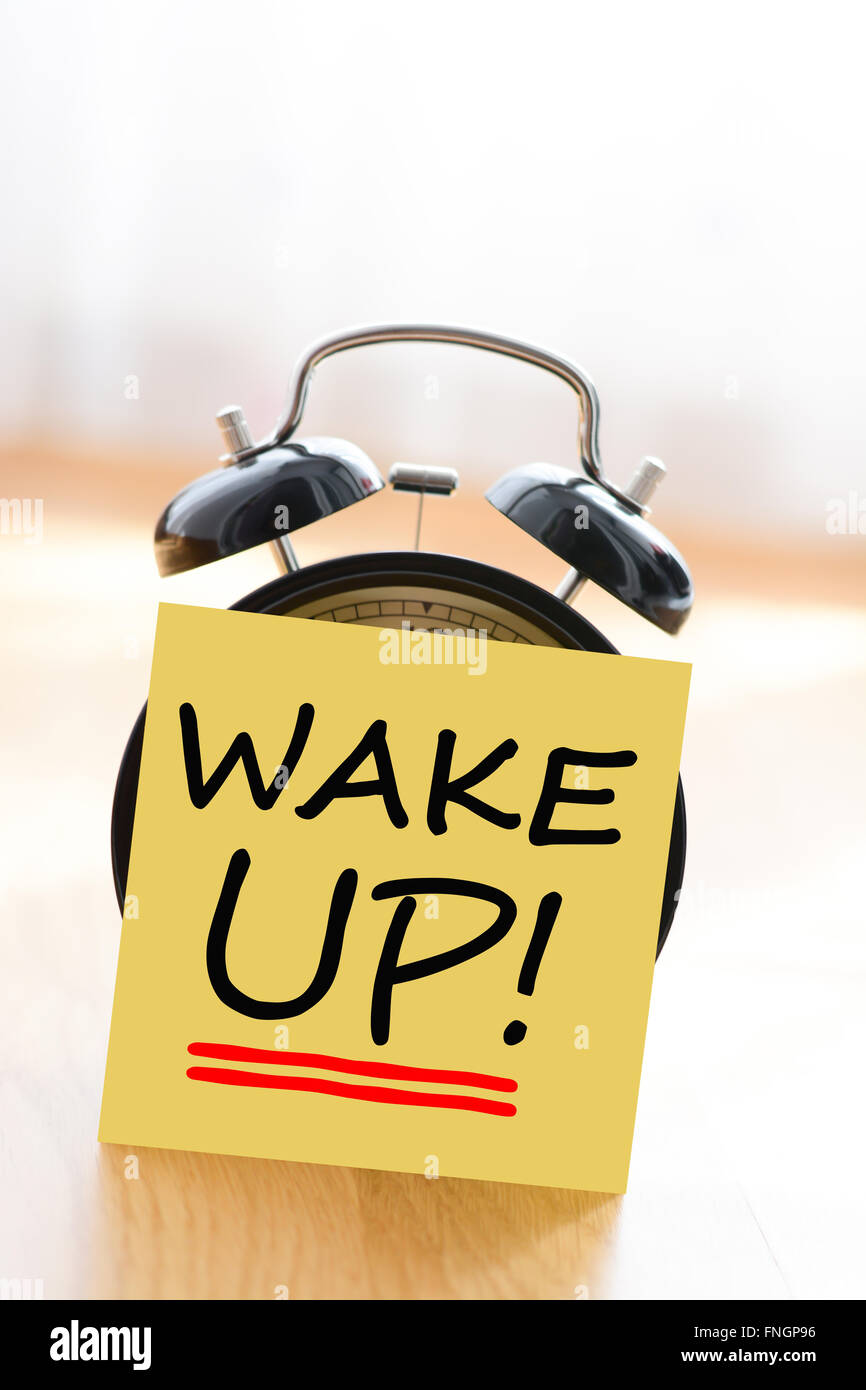 Wake up call concept with alarm clock and adhesive note Stock Photo - Alamy