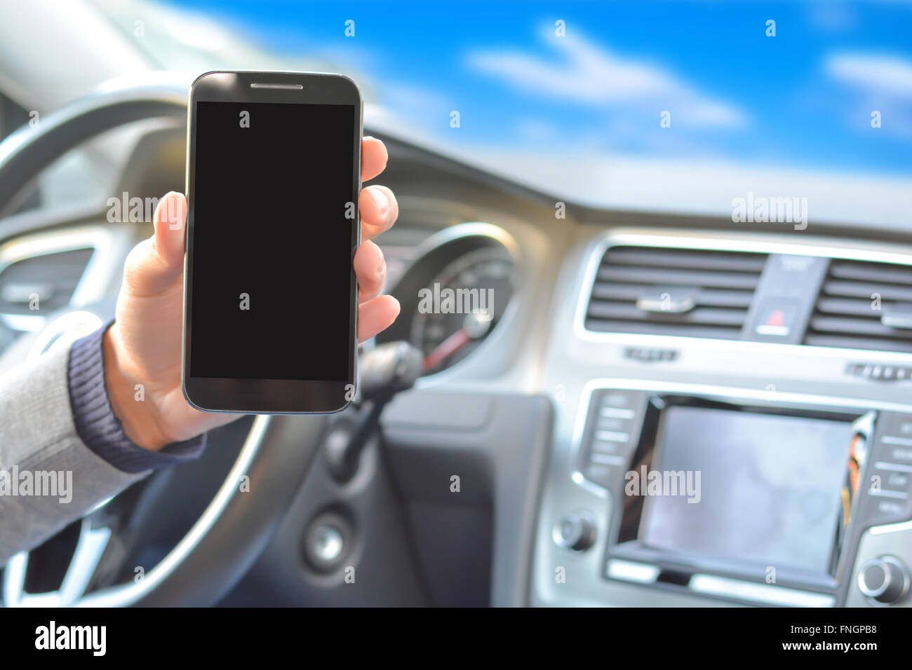 Smartphone hold by man inside a car while driving Stock Photo - Alamy