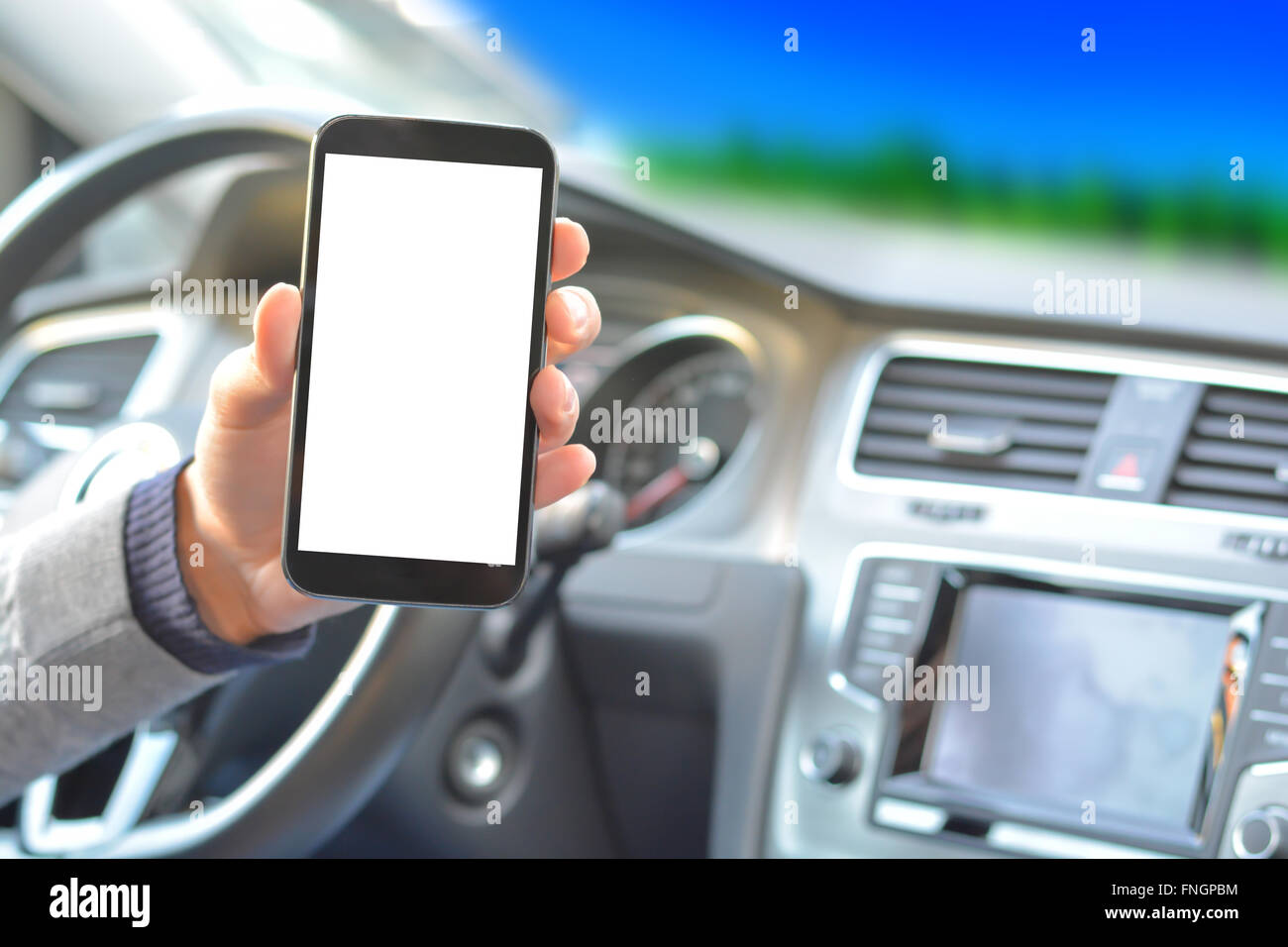 Smartphone hold by man inside a car while driving Stock Photo - Alamy