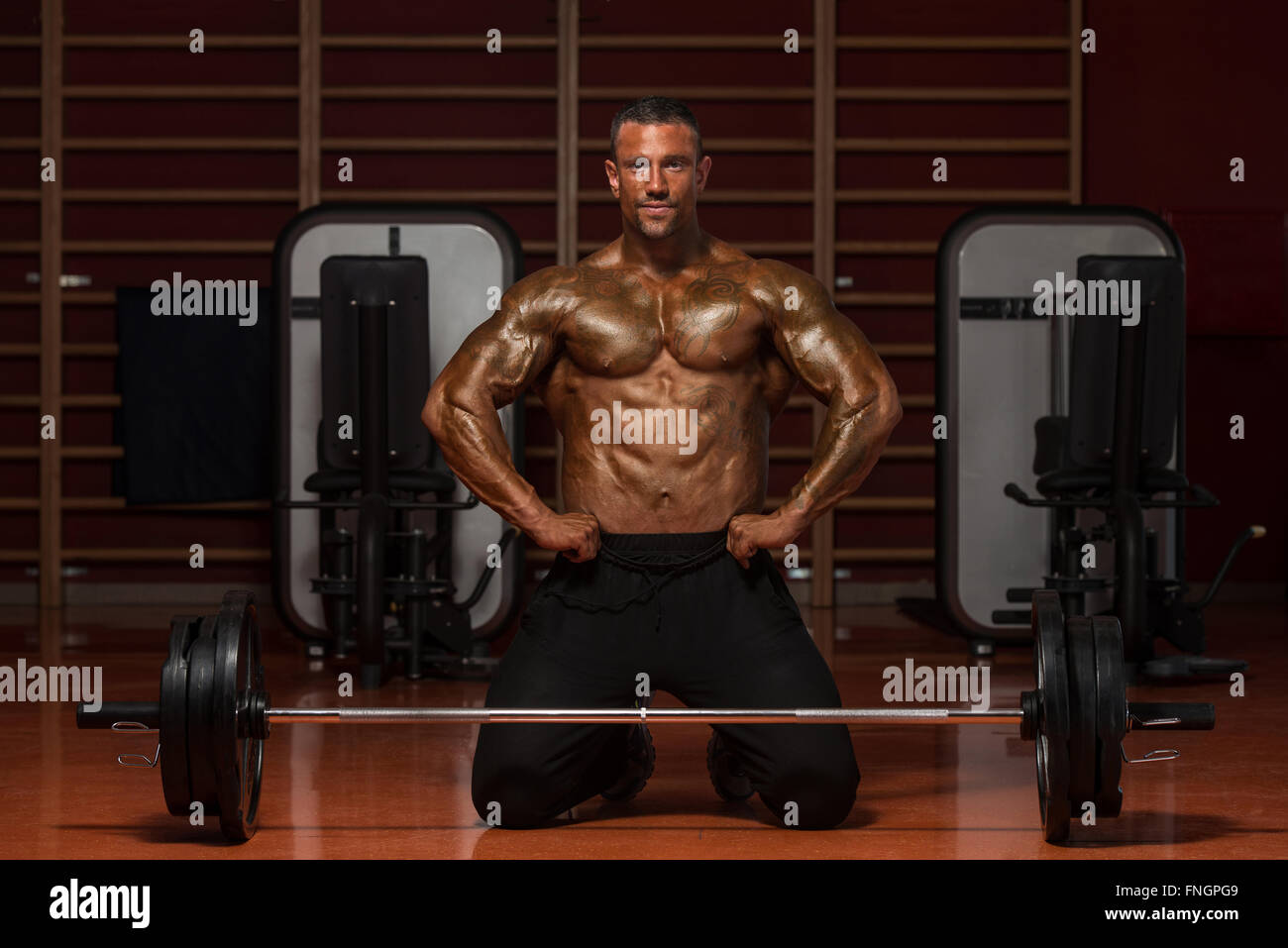 Serious Man Standing Strong In The Gym And Flexing Muscles Stock Photo ...