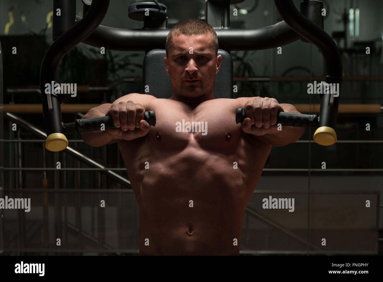 Bodybuilder Doing Heavy Weight Exercise For Chest On Machine Stock ...