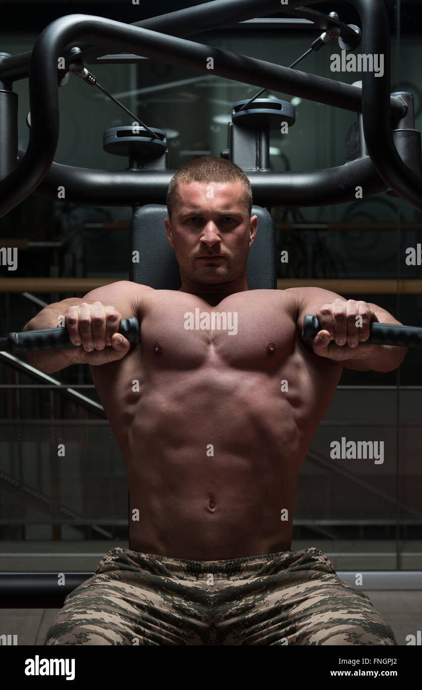 Bodybuilder Doing Heavy Weight Exercise For Chest On Machine Stock ...