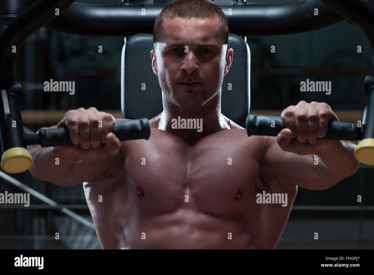 Bodybuilder Doing Heavy Weight Exercise For Chest On Machine Stock ...