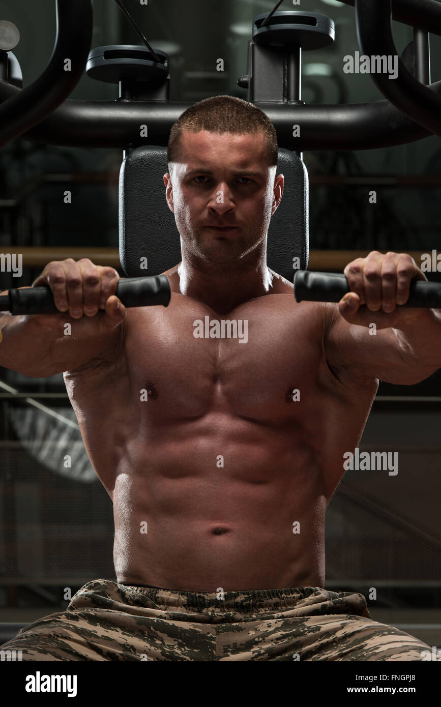 Bodybuilder Doing Heavy Weight Exercise For Chest On Machine Stock ...