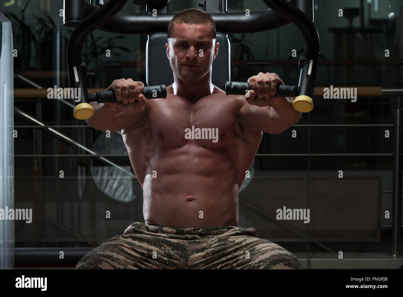 Bodybuilder Doing Heavy Weight Exercise For Chest On Machine Stock ...