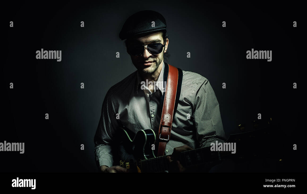 Just A Portrait Of A Man Playing An Electric Guitar Wearing A Hat And