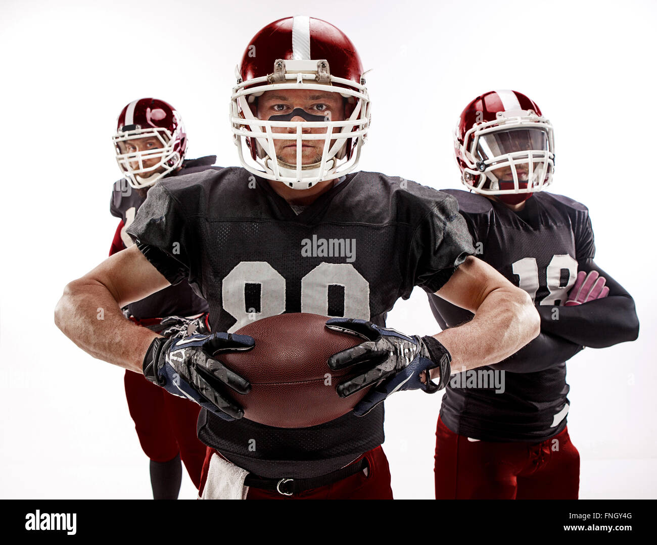 The three caucasian fitness men as american football players posing ...