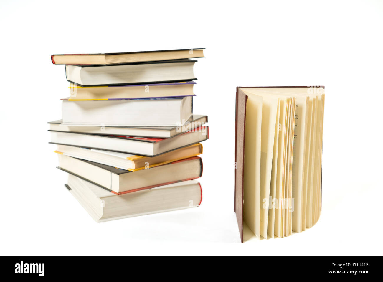 Pile of books and one open book on white background Stock Photo - Alamy