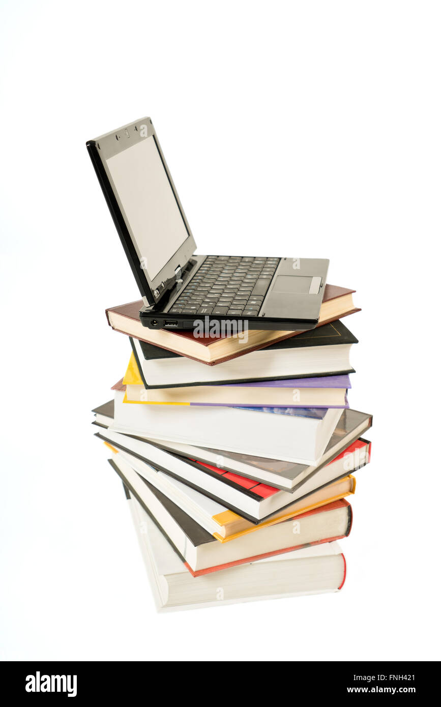 Stack of book and laptop isolated on white background Stock Photo - Alamy