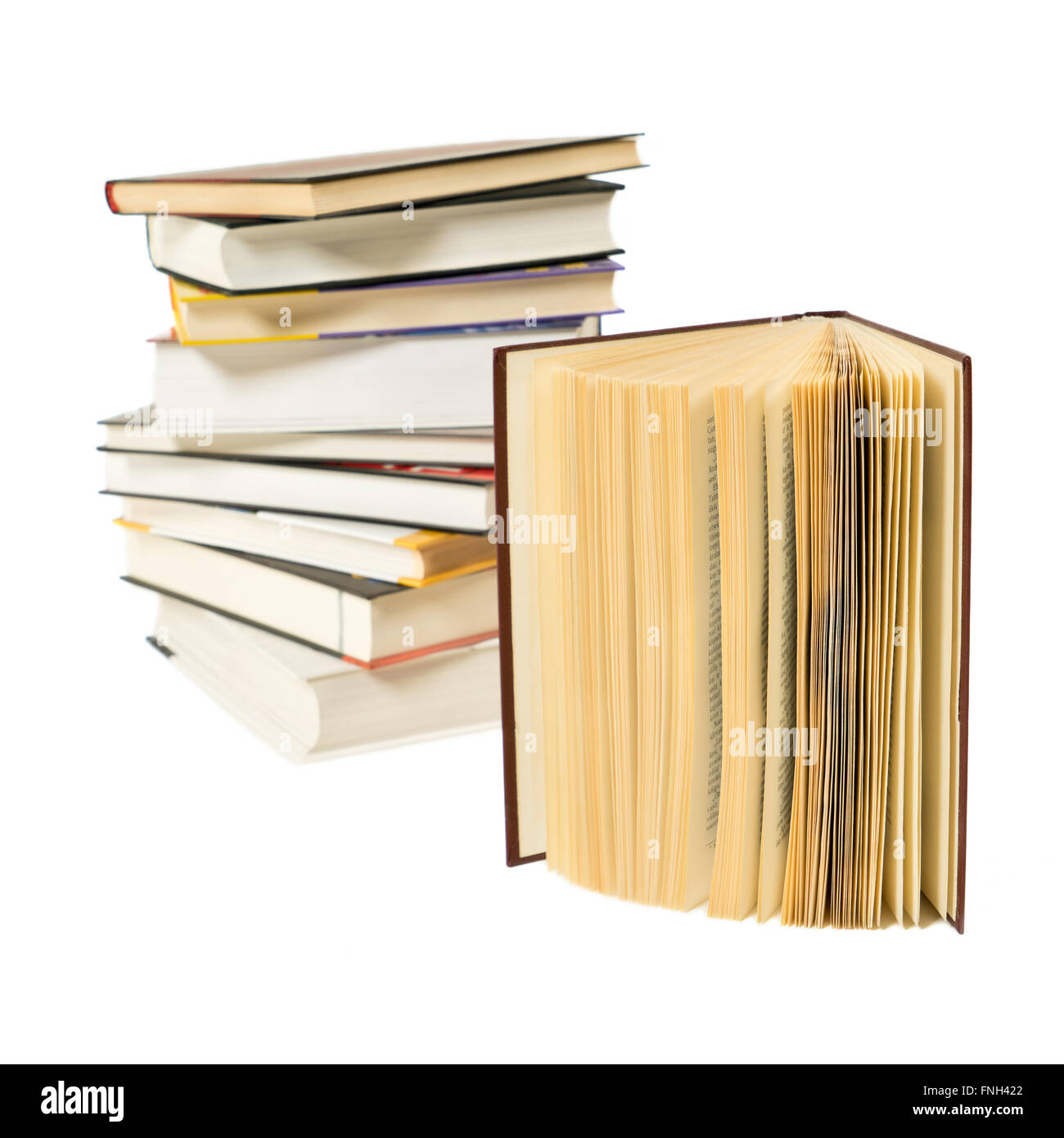 Stack of books and one open book on white background Stock Photo - Alamy