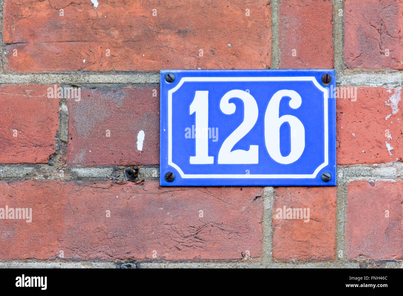 House number 126 sign on wall Stock Photo - Alamy