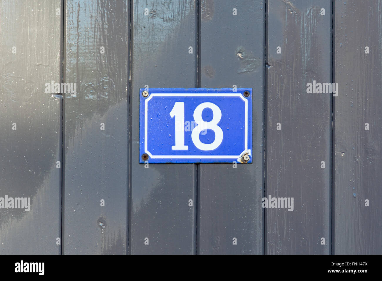House number 18 sign on wooden gate Stock Photo - Alamy