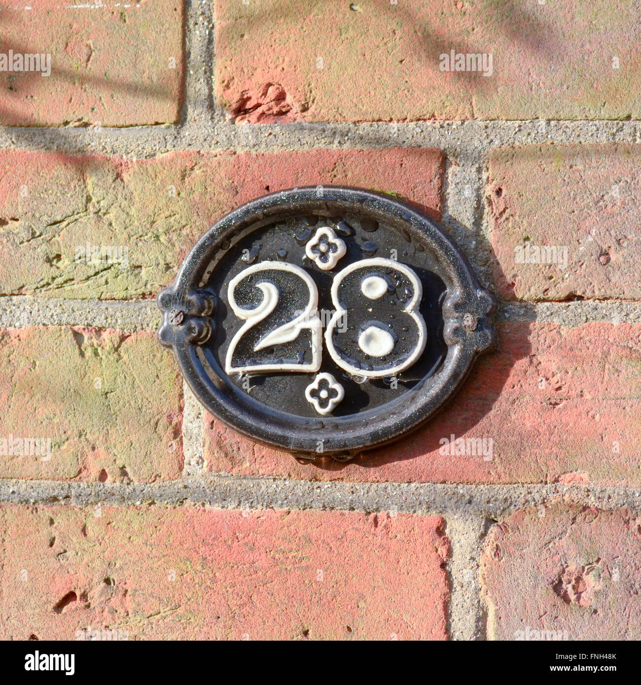 House number 28 sign on wall Stock Photo - Alamy