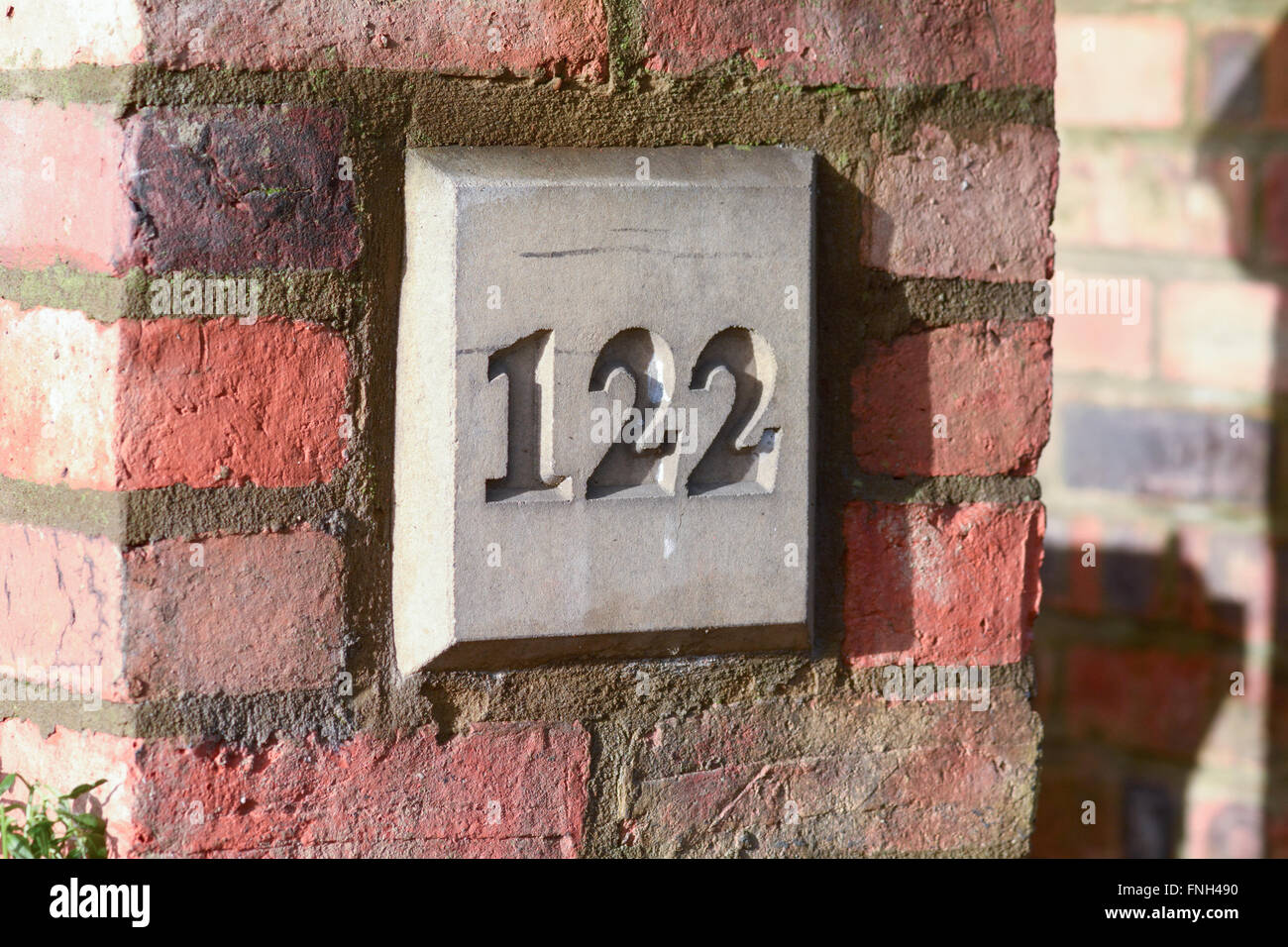 House number 122 sign on wall Stock Photo - Alamy