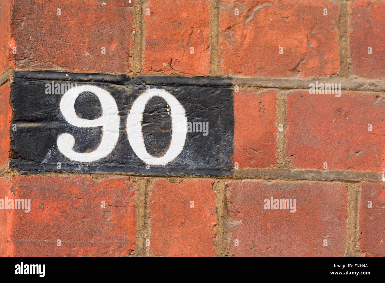 House number 90 painted sign on wall Stock Photo - Alamy