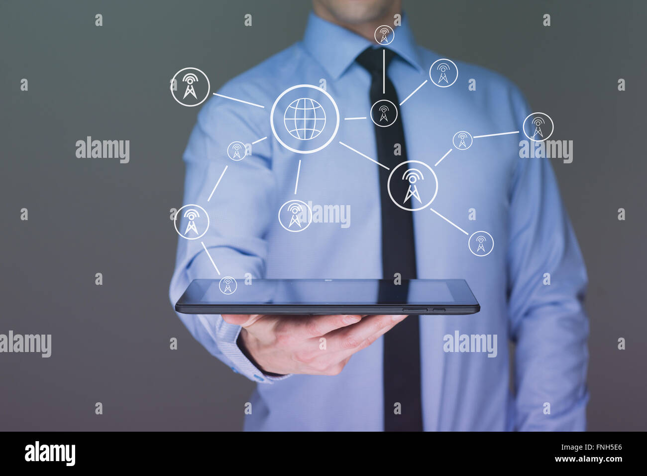 businessman holding a tablet pc. Shows telecommunication towers ...