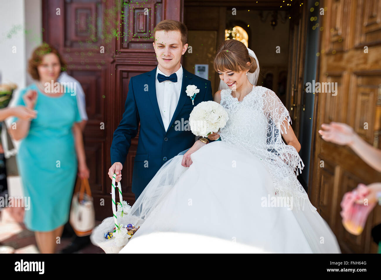Guest sprinkle with colored rice wedding couple Stock Photo - Alamy