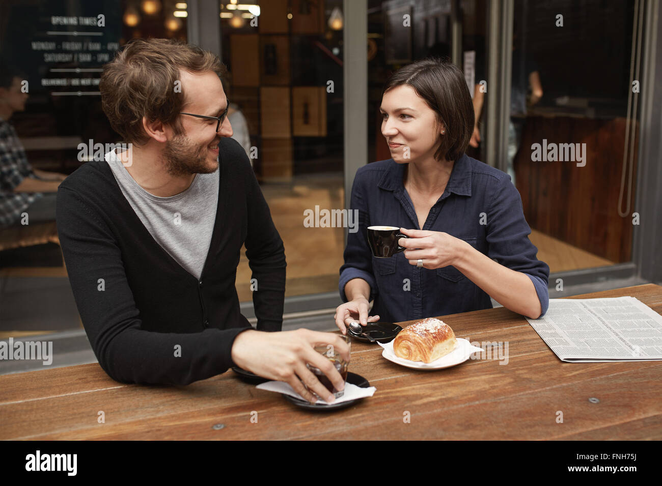Smiling young stylish couple on a coffee date outdoors Stock Photo - Alamy
