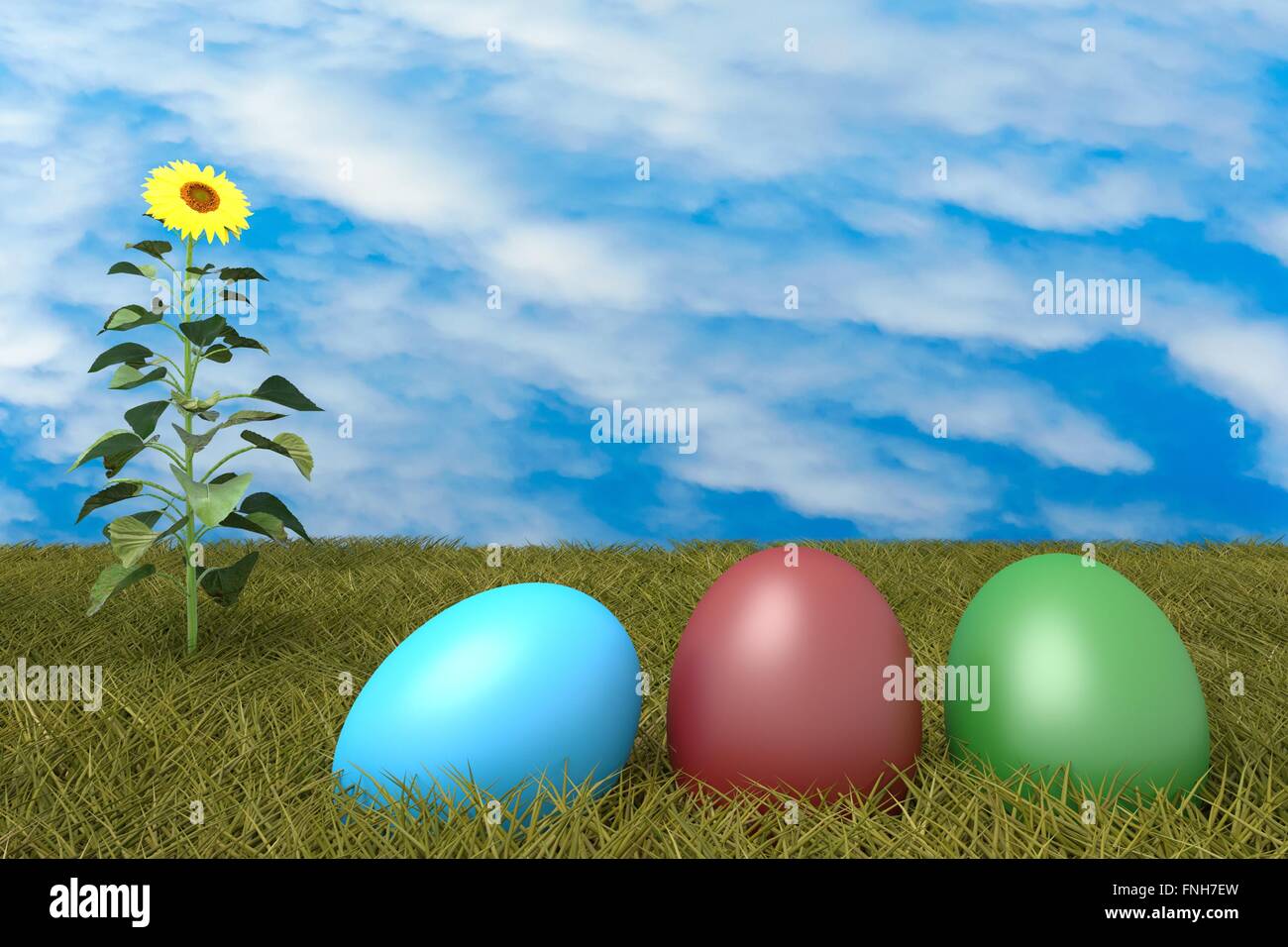 Easter eggs on gras with blue cloudy sky and sunflower Stock Photo - Alamy