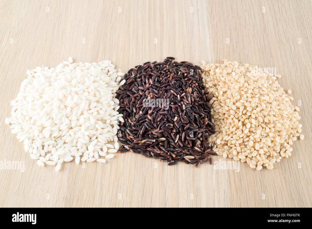 Rice thai black, brown rice, carnaroli rice on wooden table Stock Photo ...