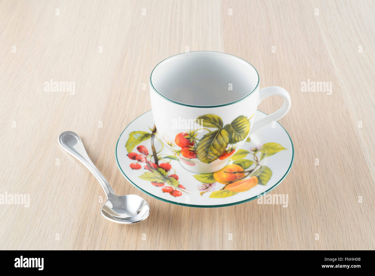 Cup of tea and teaspoon on wooden table Stock Photo - Alamy