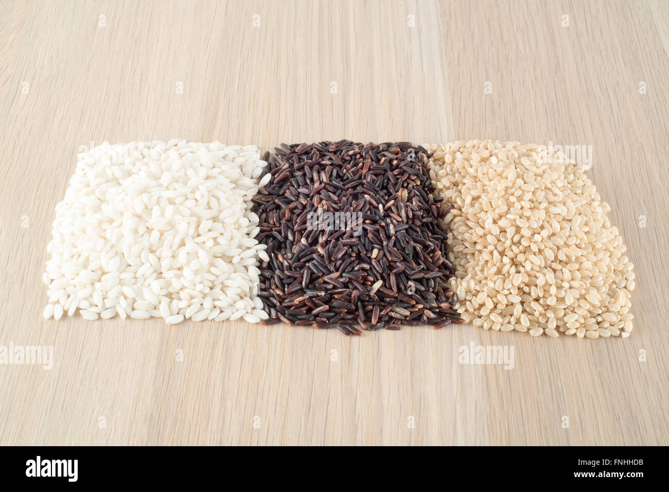 Rice thai black, brown rice, carnaroli rice on wooden table Stock Photo ...
