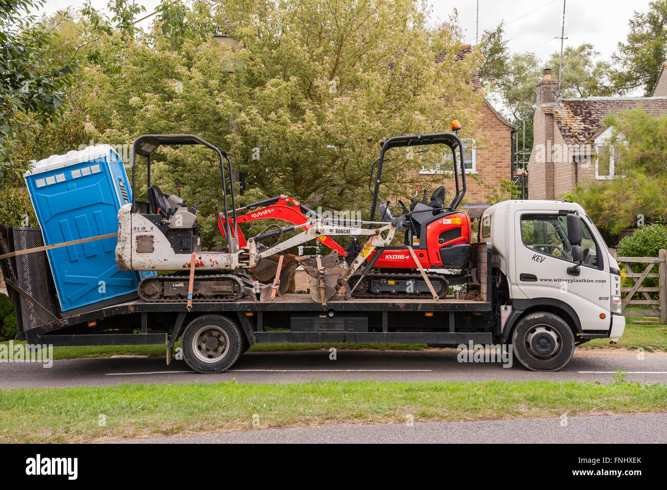 Mini diggers and aon the back of a lorry in the Uk Stock Photo - Alamy
