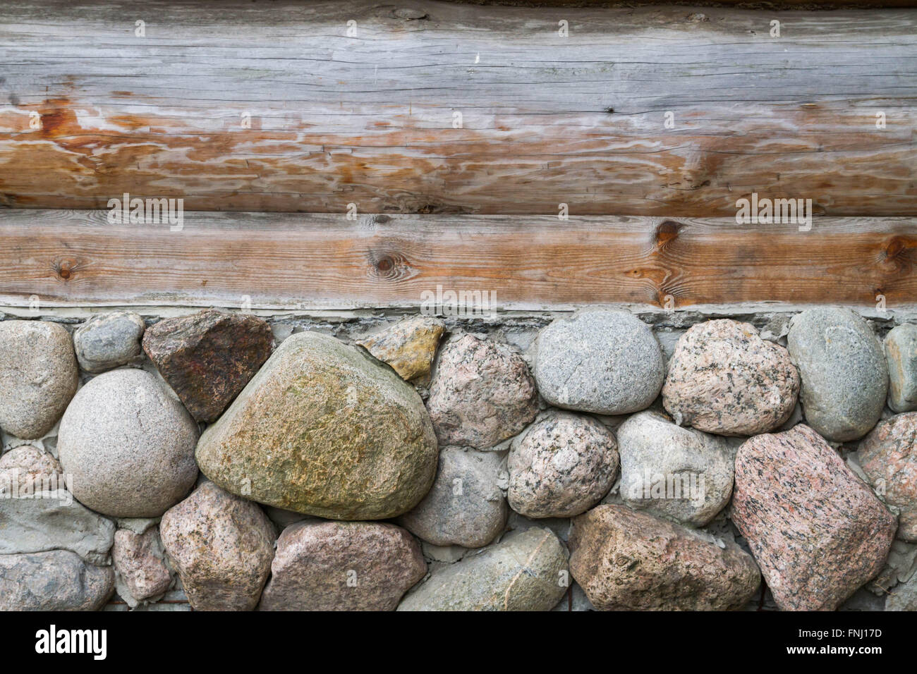 Wood log cabin with stone wall Stock Photo - Alamy