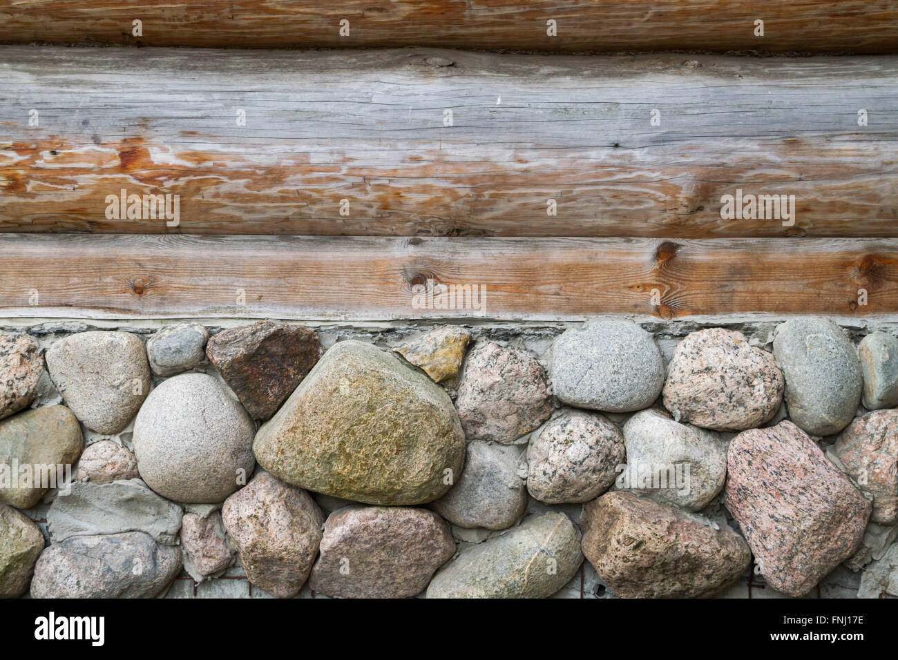 Wood log cabin with stone wall Stock Photo - Alamy