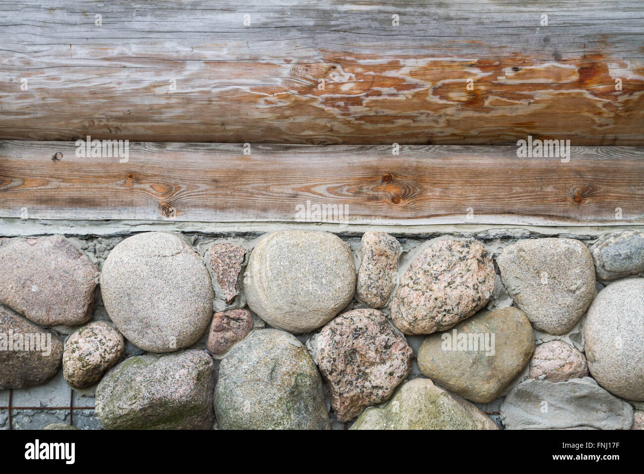 Wood log cabin with stone wall Stock Photo - Alamy