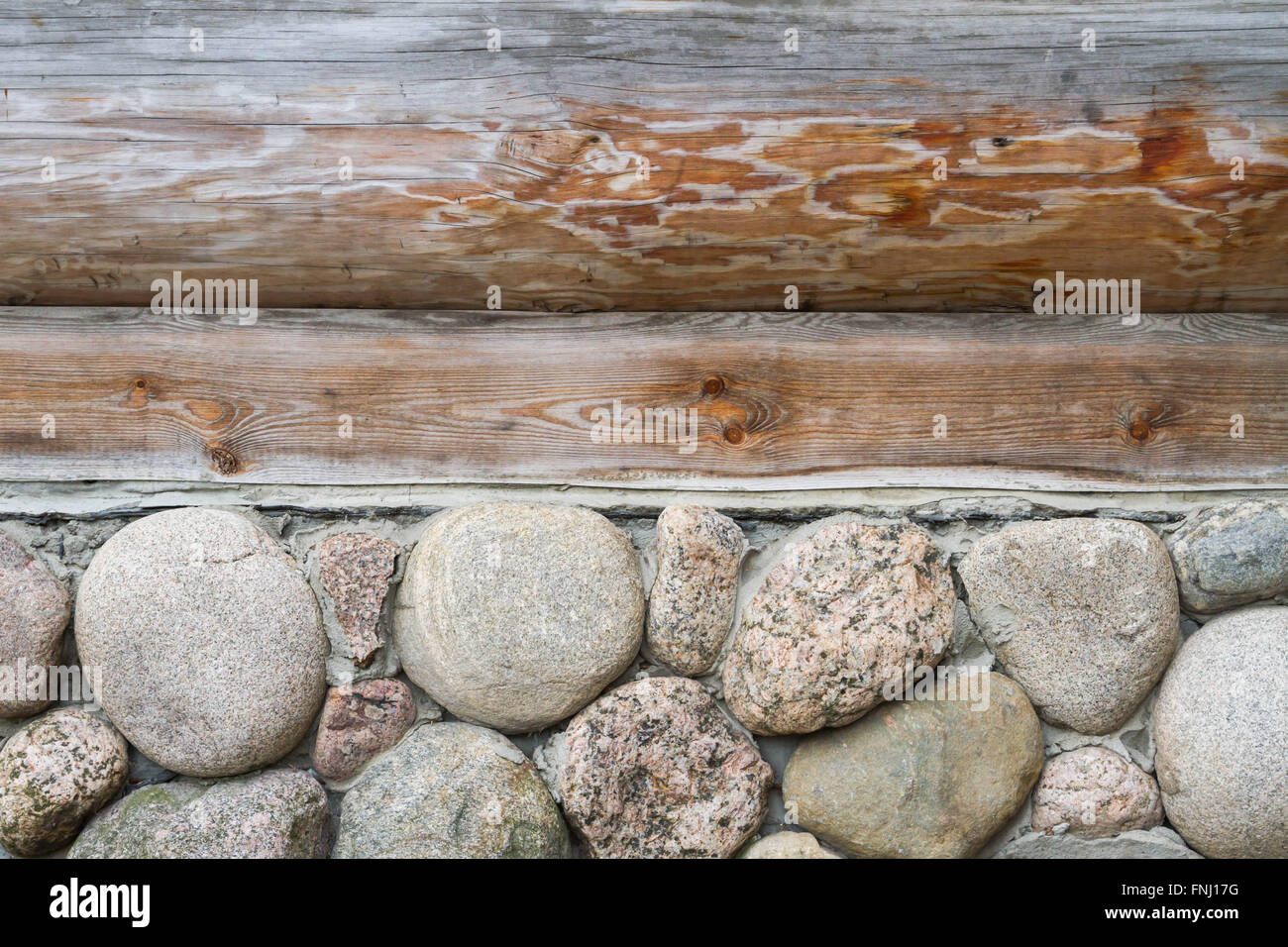 Wood log cabin with stone wall Stock Photo - Alamy