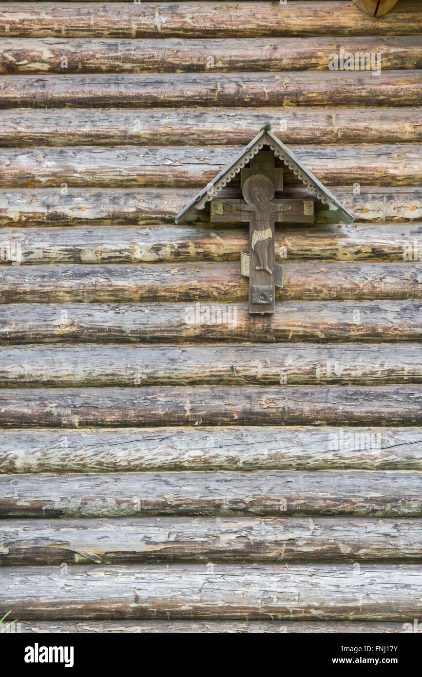 A wooden cross with the image of the cross on the log wall Stock Photo ...