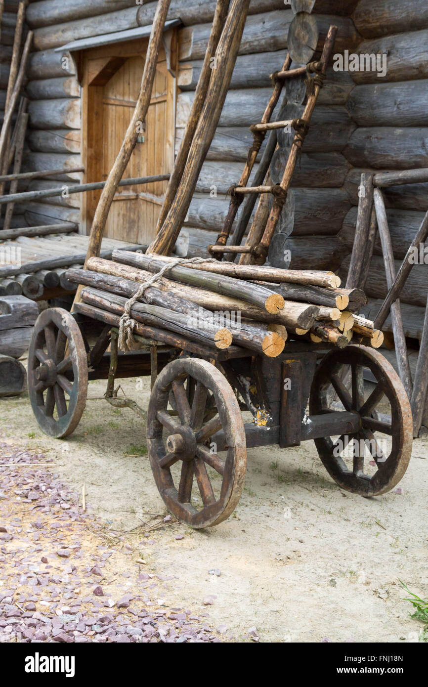 Old wooden cart with attached logs on it Stock Photo - Alamy
