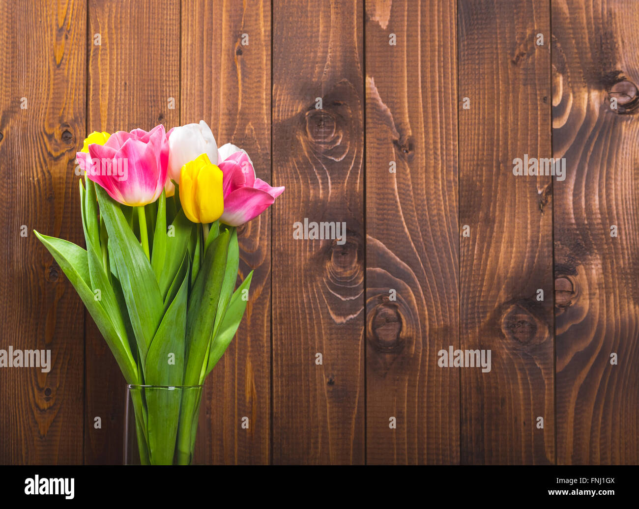 Bouquet Of Tulips In Front Of Spring Scene On The Wooden Background. A ...