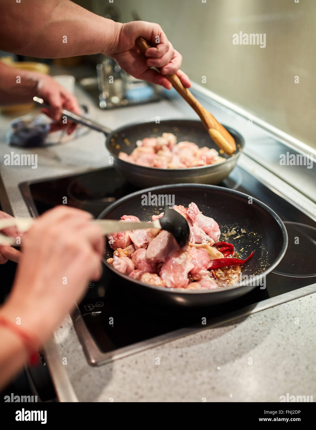 Two woman cooking on a stove hi-res stock photography and images - Alamy