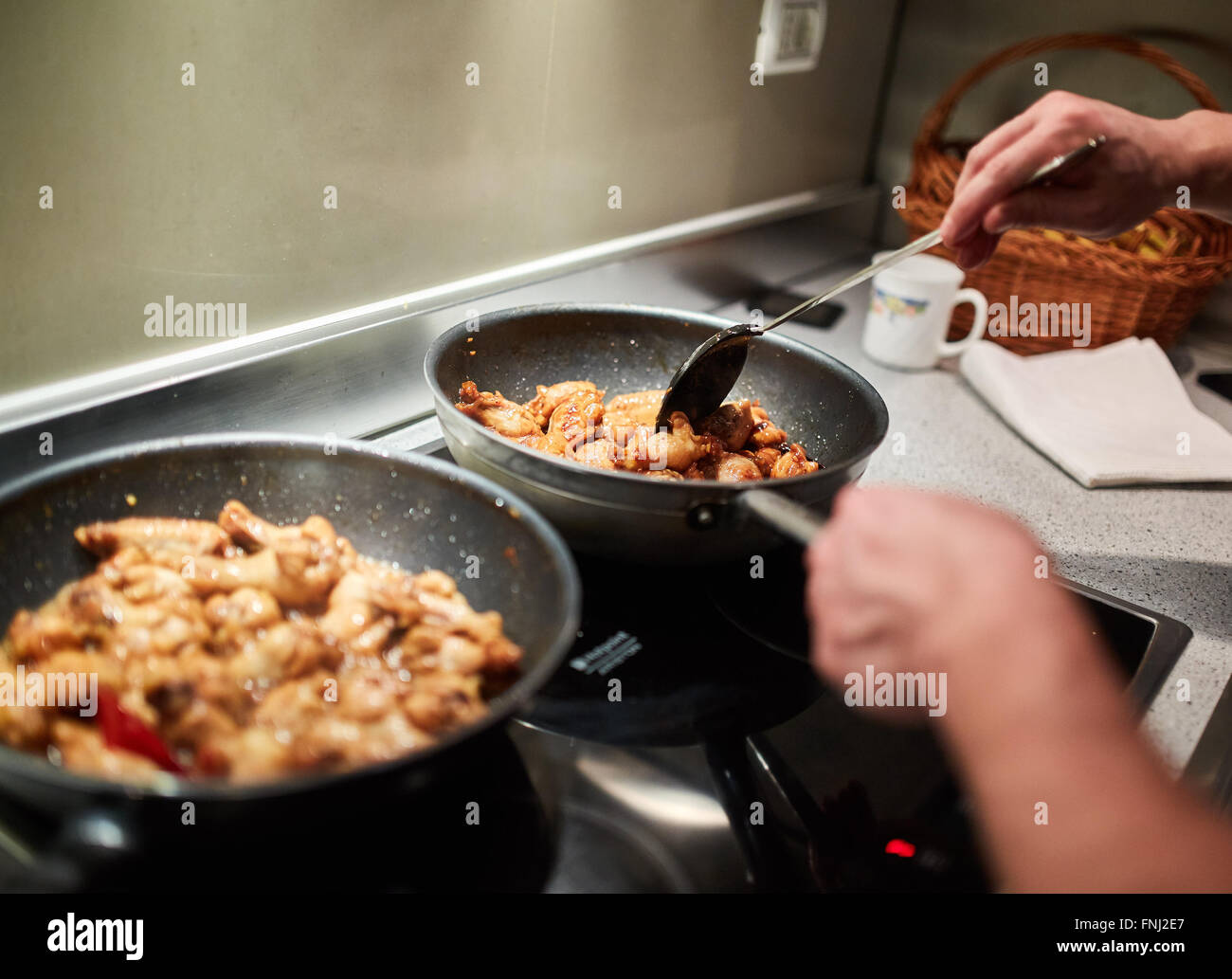 Man cooking at home alone a thai recipe in wok pans Stock Photo - Alamy
