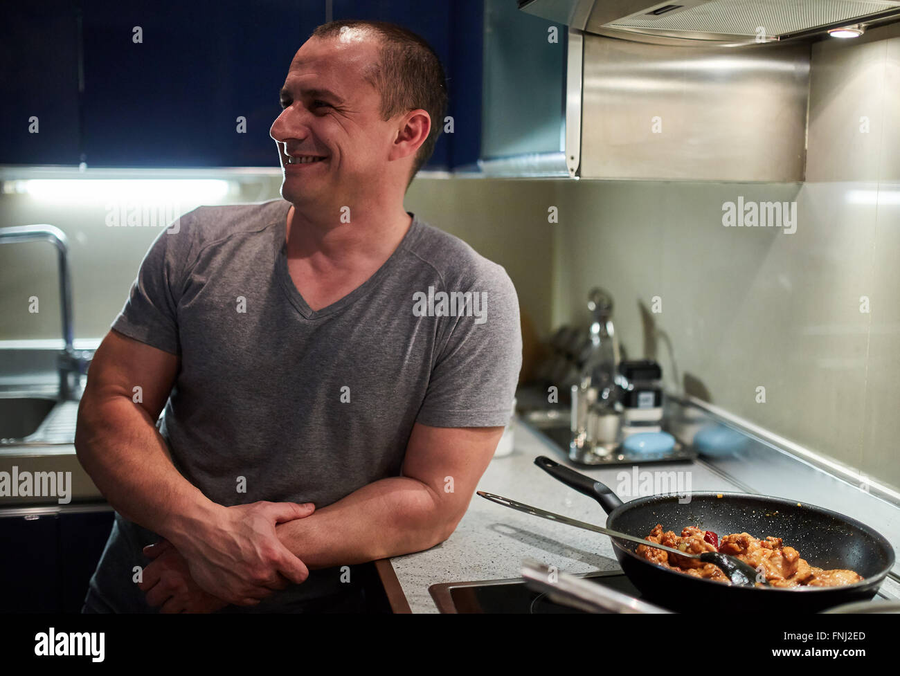 Man cooking at home alone a thai recipe in wok pans Stock Photo - Alamy